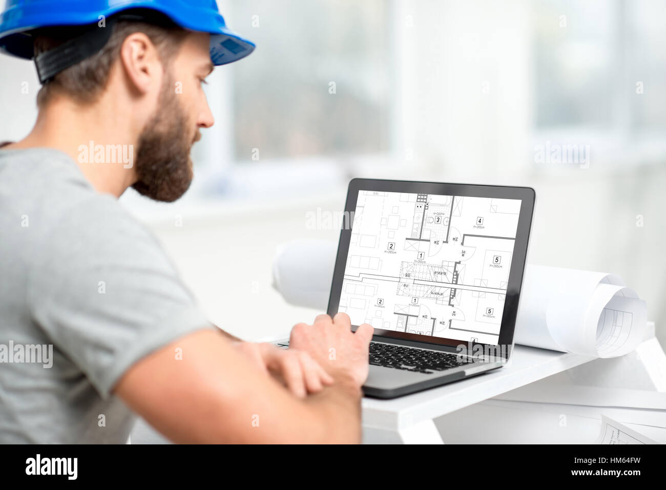 Architect working with laptop at the structure interior Stock Photo - Alamy