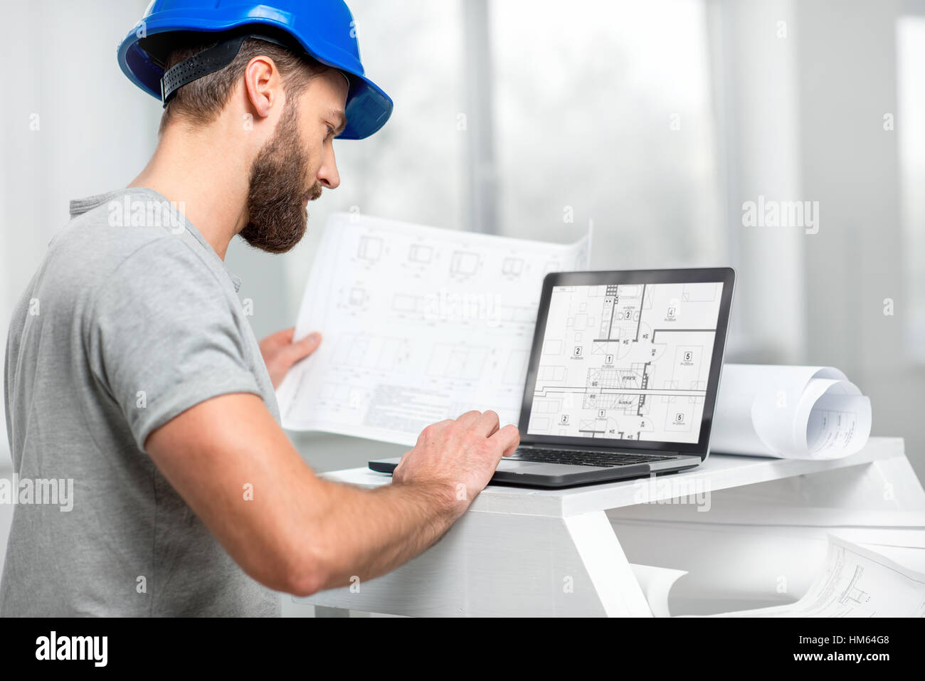 Architect working with laptop at the structure interior Stock Photo - Alamy