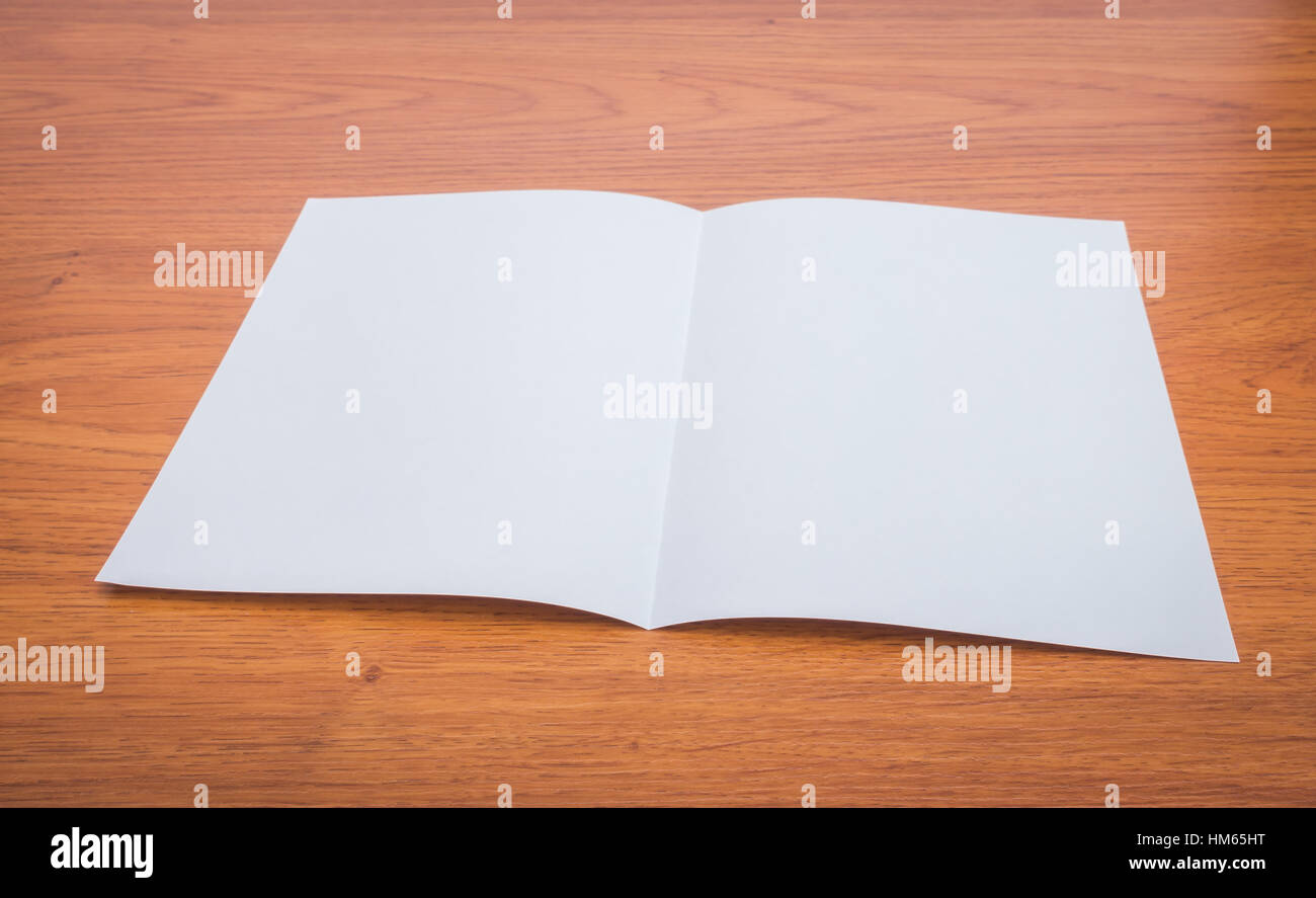 Bifold white template paper on wood texture Stock Photo - Alamy