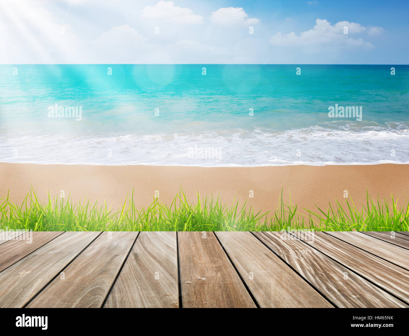 Wood terrace on the beach with green grass and sun light Stock Photo ...