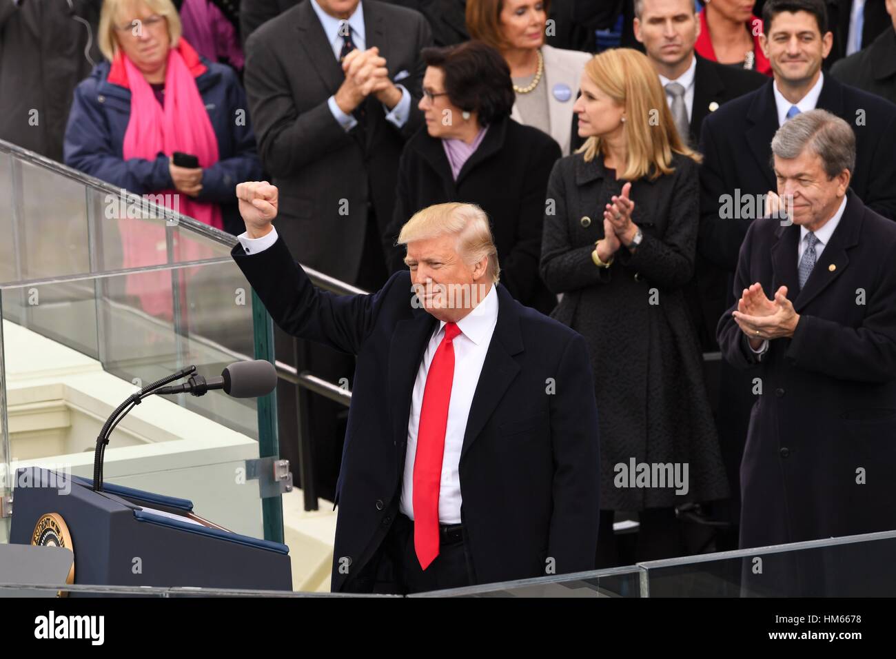 President Donald Trump holds his fist high after taking the oath of ...