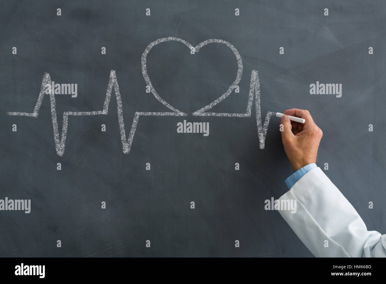 Doctor drawing pulse trace and heart on blackboard Stock Photo - Alamy
