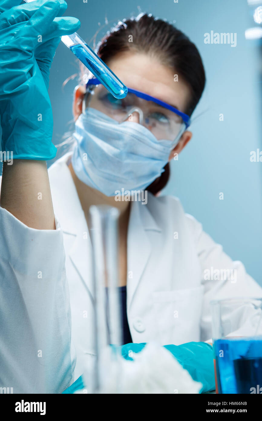Lab assistant experiments with reagents Stock Photo - Alamy