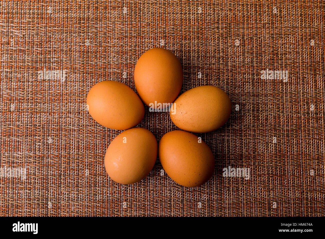 Five eggs on a texture background Stock Photo - Alamy