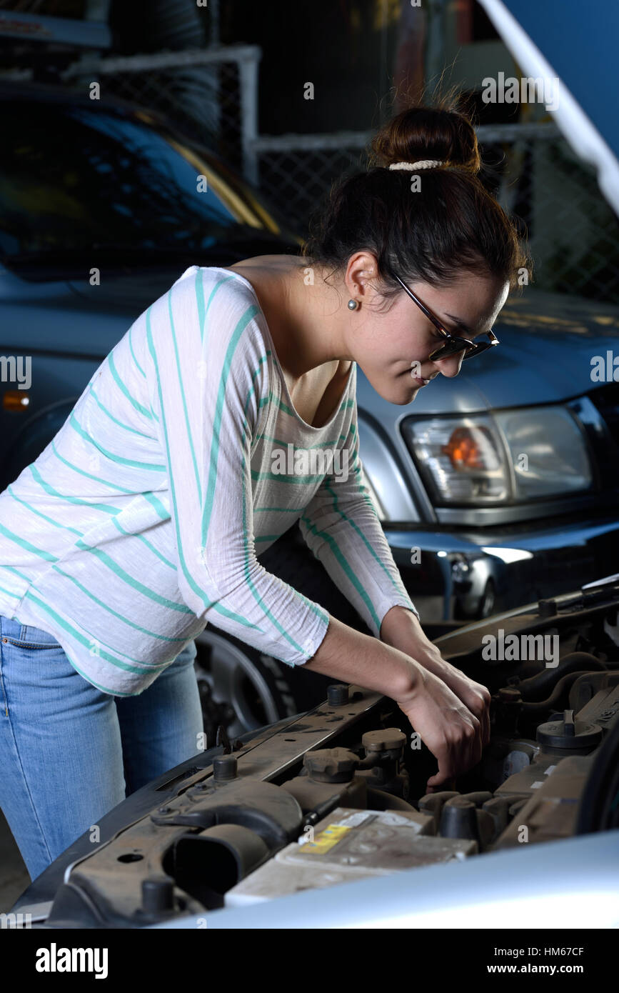 Girl checking car engine and using sunglasses Stock Photo - Alamy