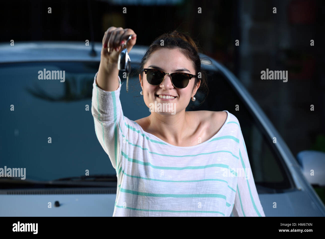 young girl hold key of modern gray car Stock Photo - Alamy