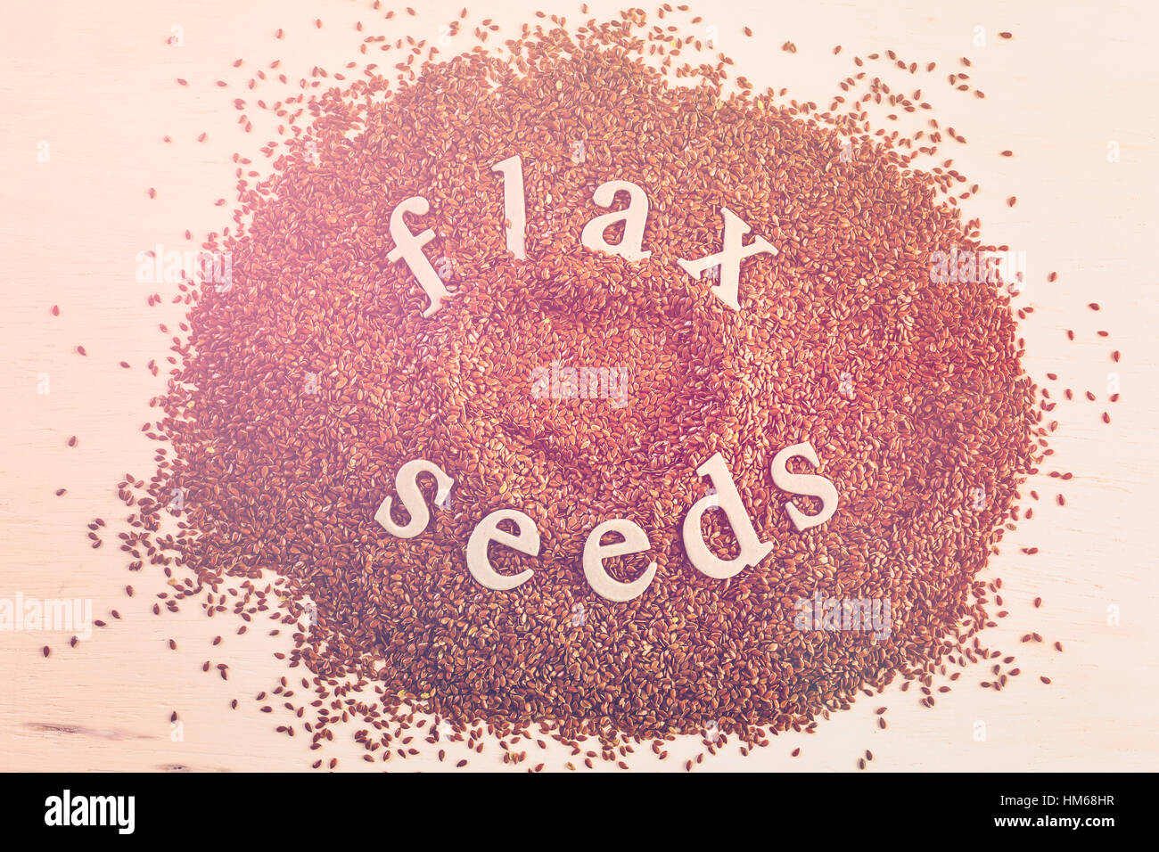 Flax seeds on painted wood board Stock Photo - Alamy