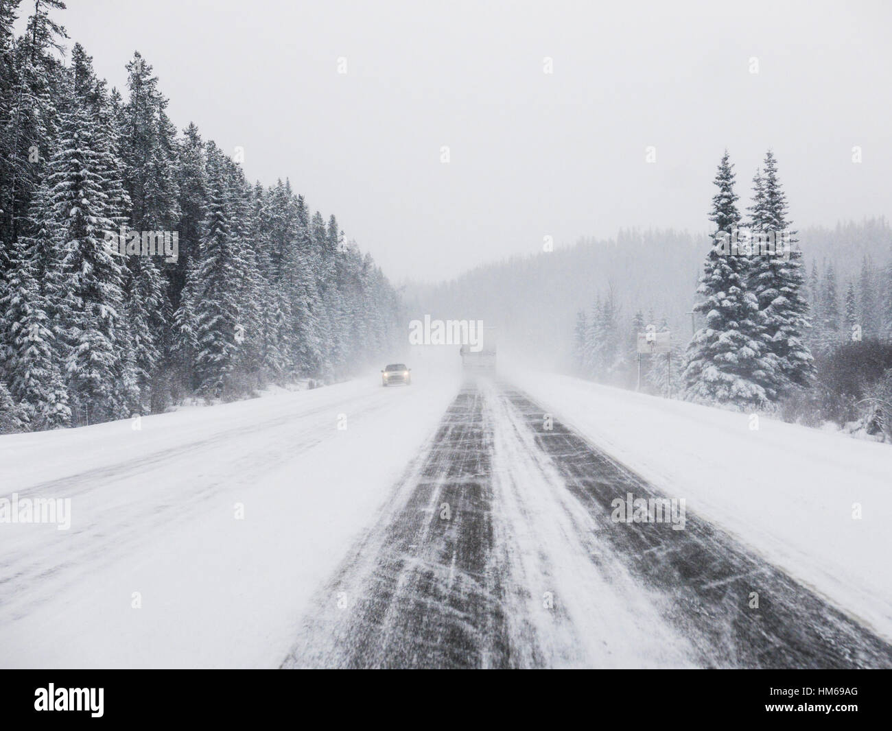 Snowy winter scene of cars and trucks on Trans-Canada Highway near ...