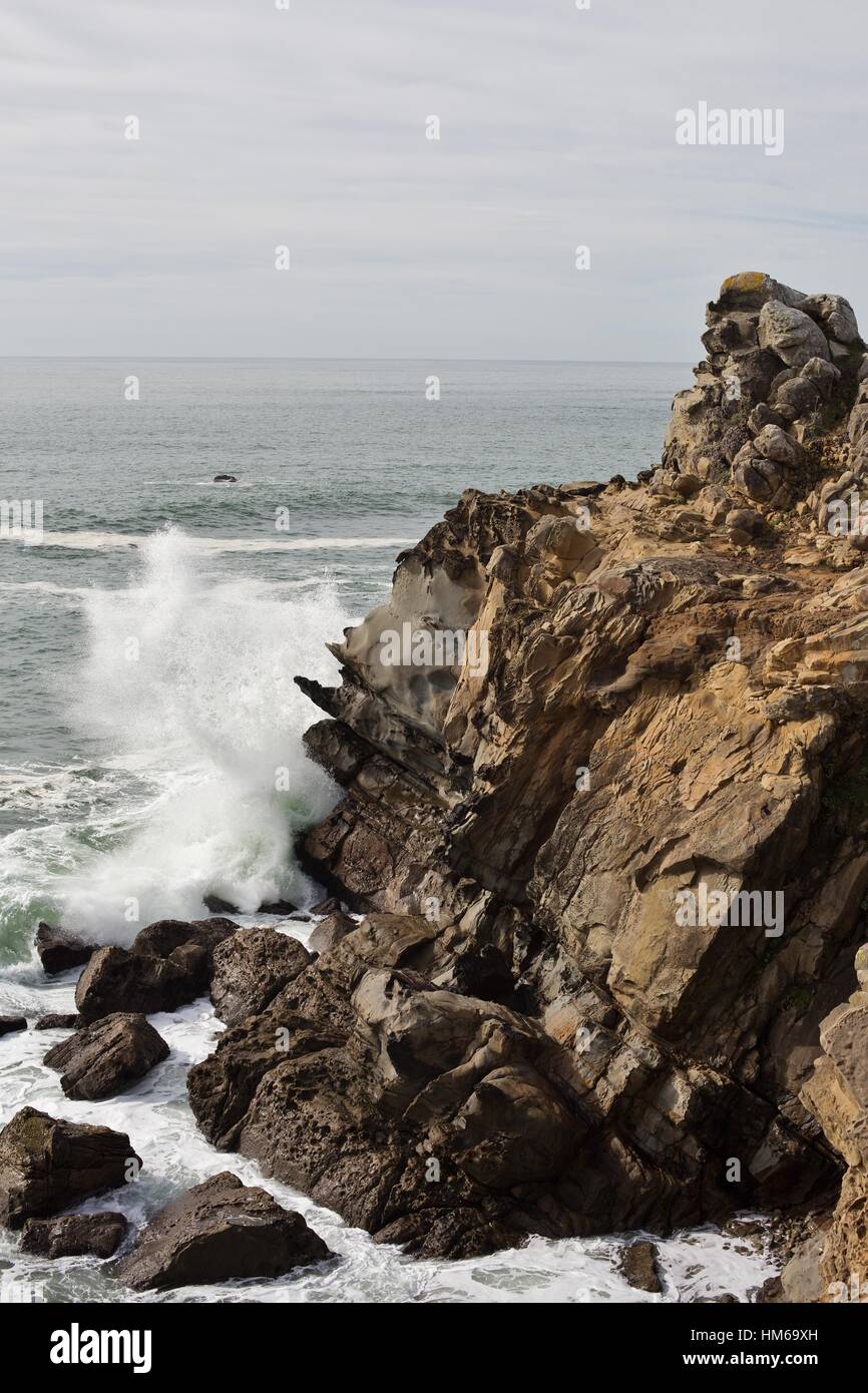 Waves splashing against a rocky cliff at Salt Point State Park in ...