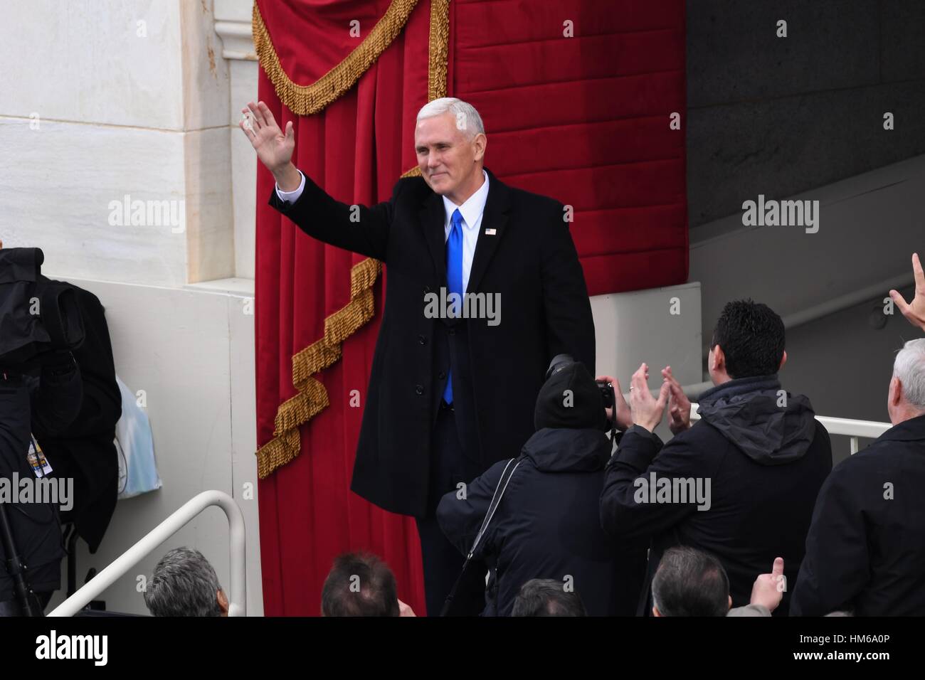 Vice President elect Mike Pence waves as he walks from the U.S. Capitol ...