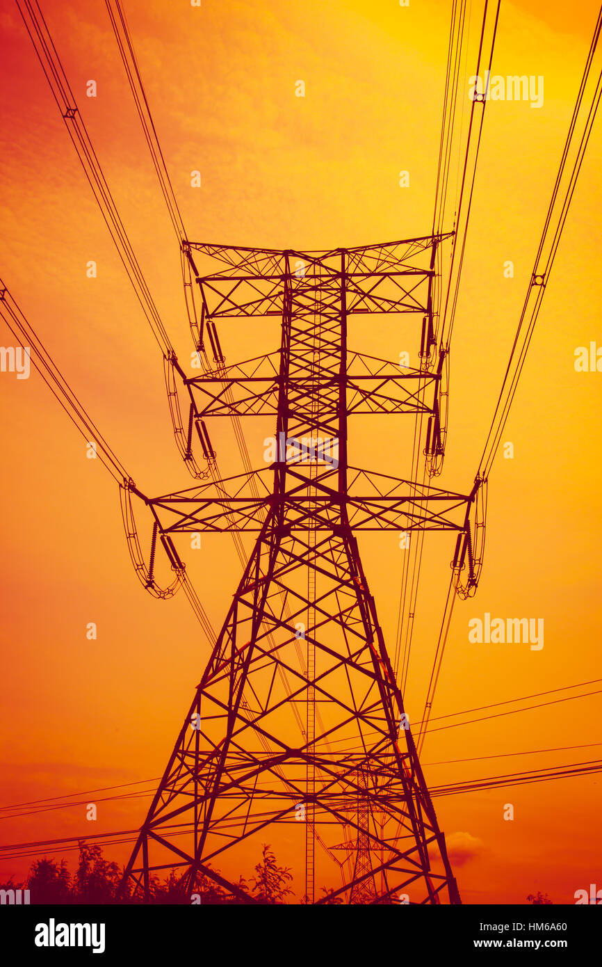 High voltage Electricity post on sunset sky Stock Photo - Alamy