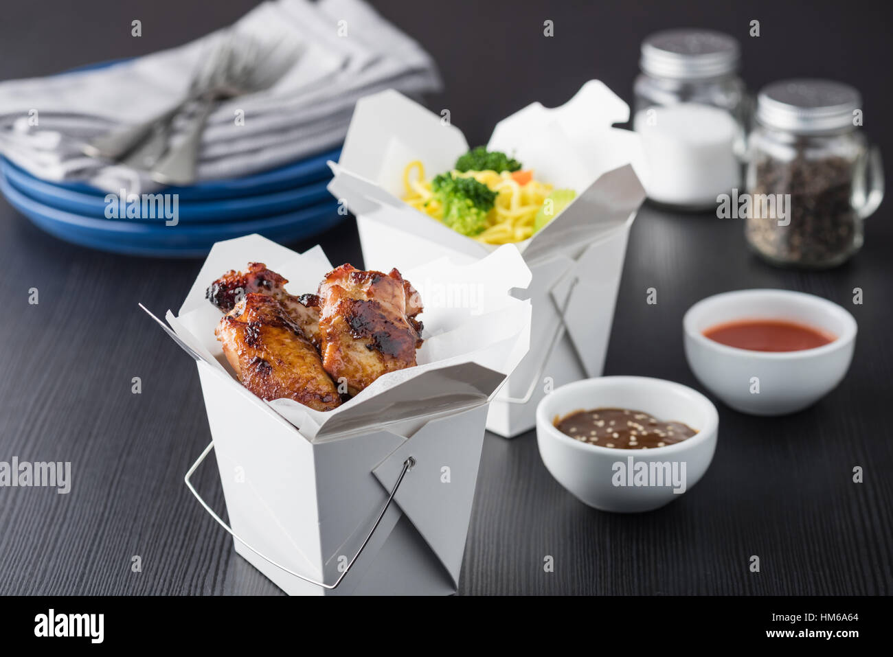 Asian chicken wings and noodles in take-out box Stock Photo - Alamy