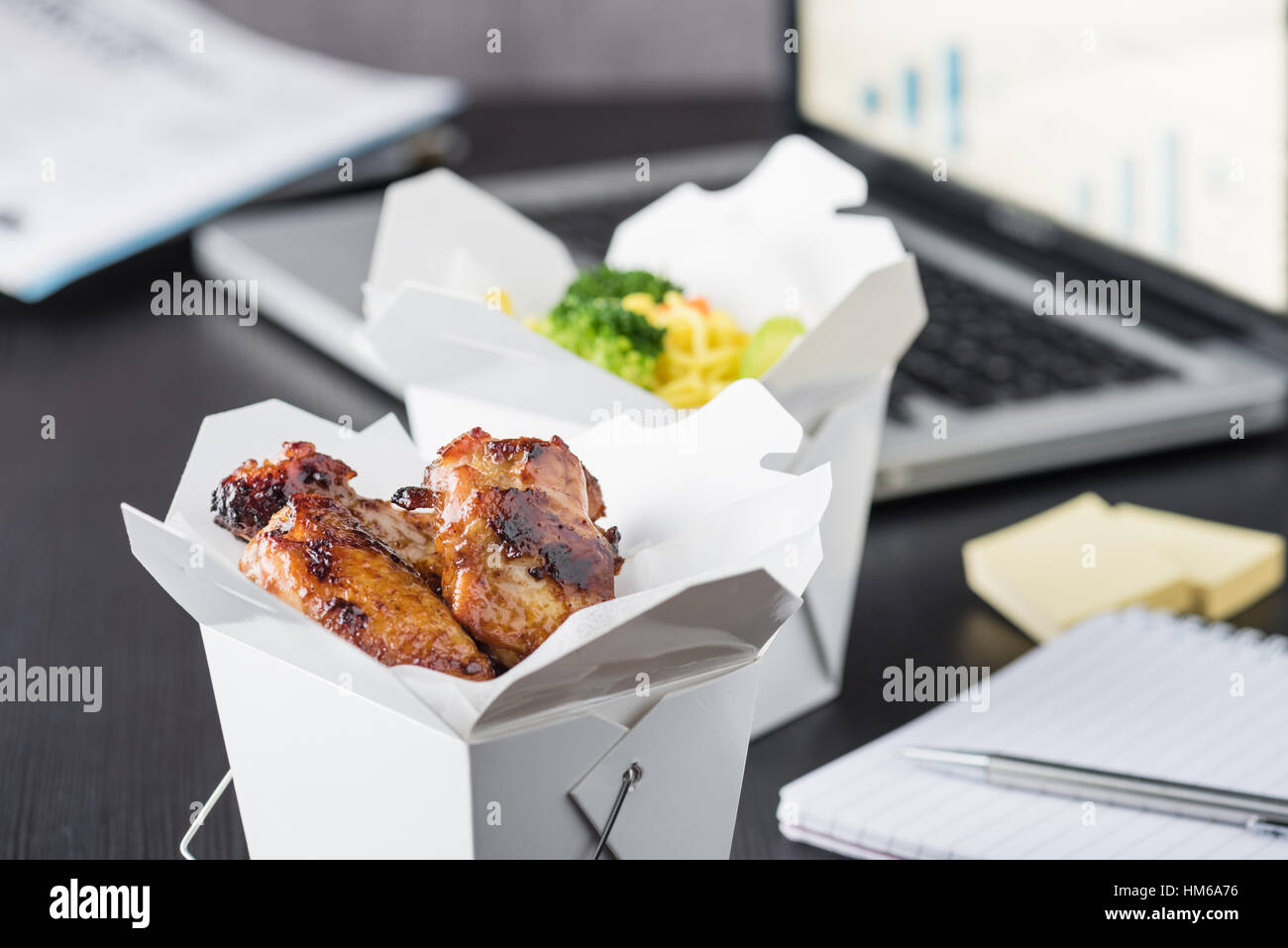 Chicken wings and noodles in noodles box at office lunch Stock Photo ...