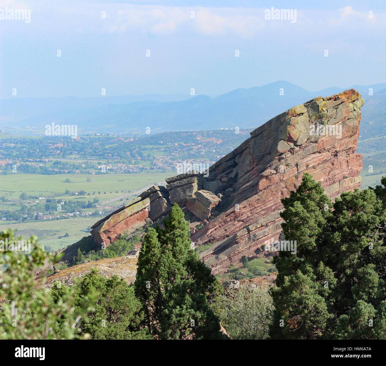 Red rock juts from the ground Stock Photo - Alamy