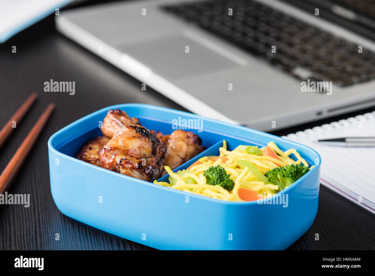 Chicken wings and noodles in bento box at office lunch Stock Photo - Alamy