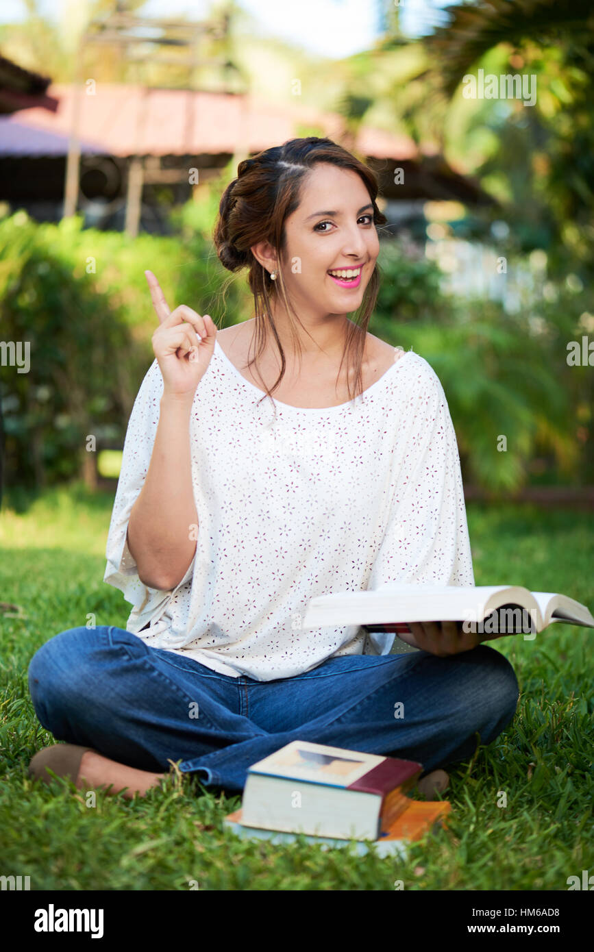 lady with and idea holding books at the park Stock Photo - Alamy