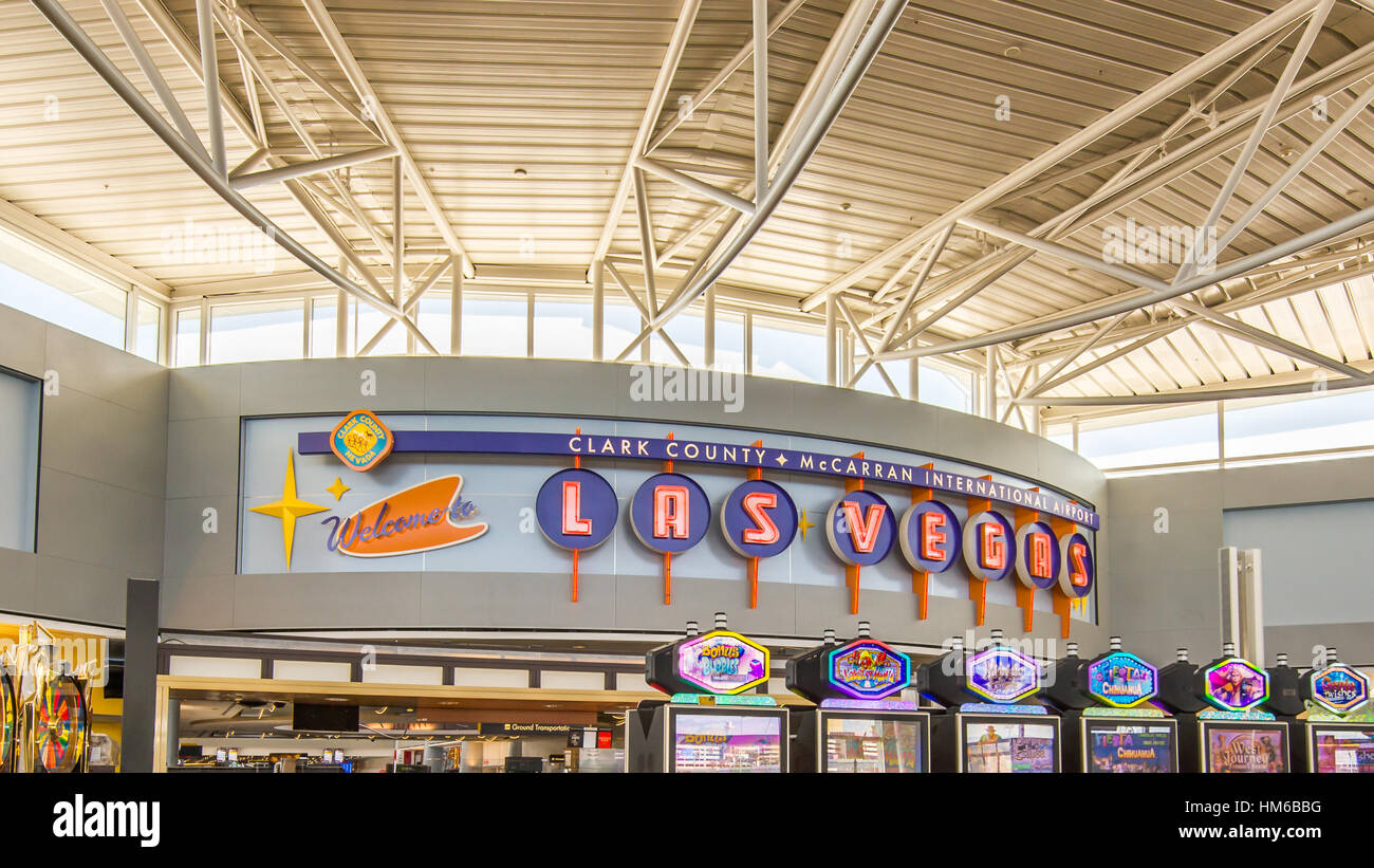 Slot machines at McCarran International Airport terminal below a ...