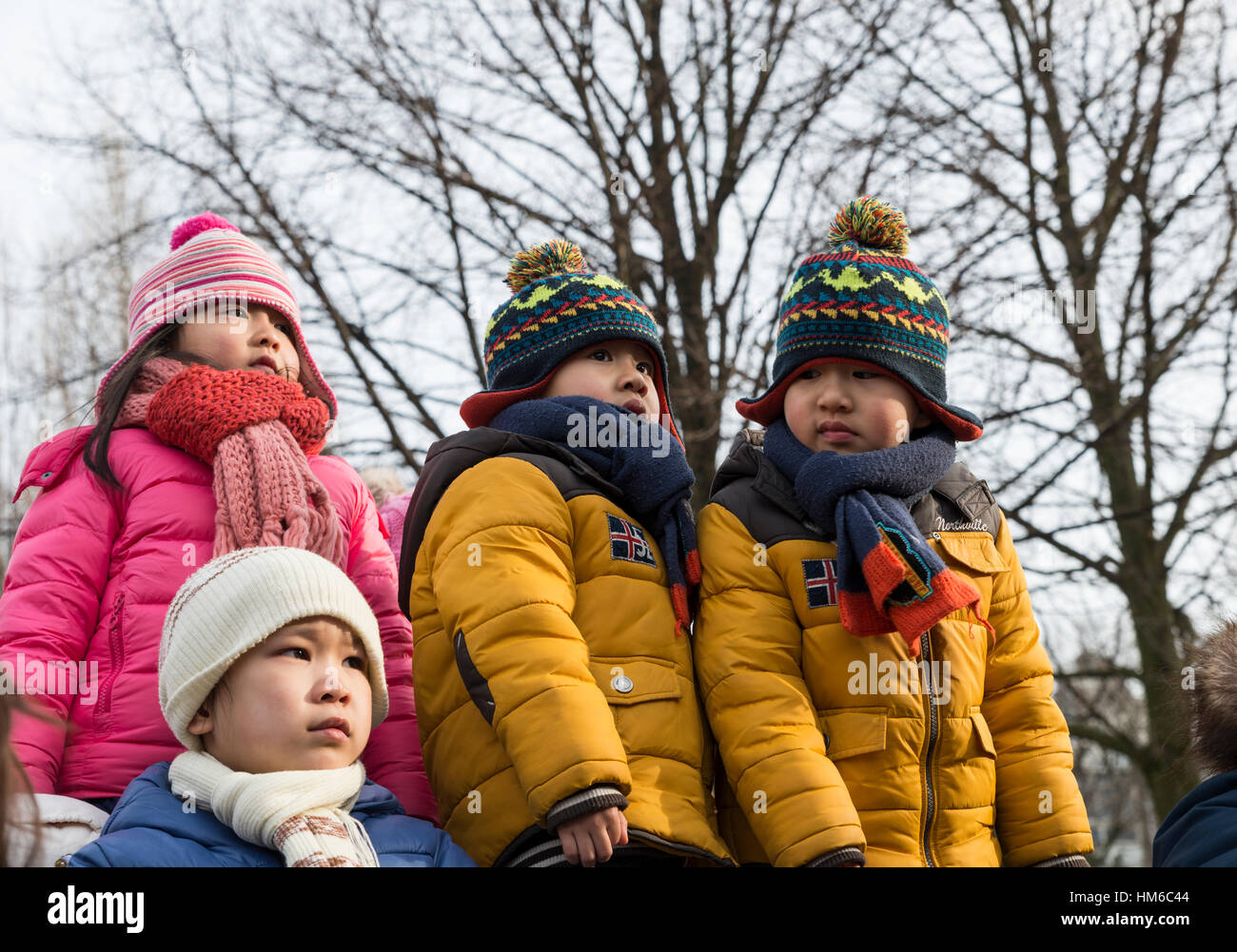 ROTTERDAM,HOLLAND - JANUARY 28 2016: four chinese children watching the ...