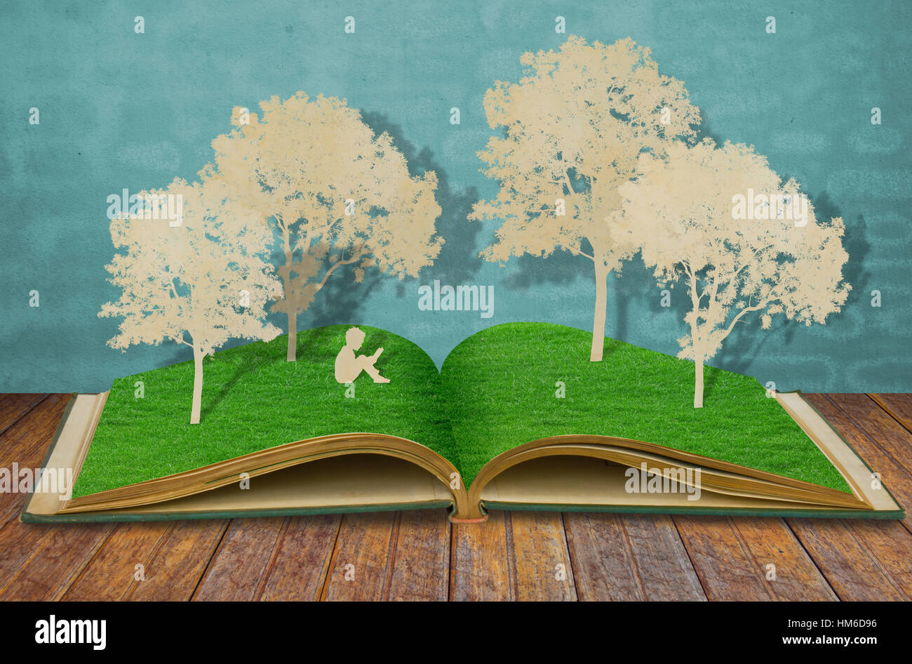 Paper cut of children read a book under tree on old book Stock Photo ...