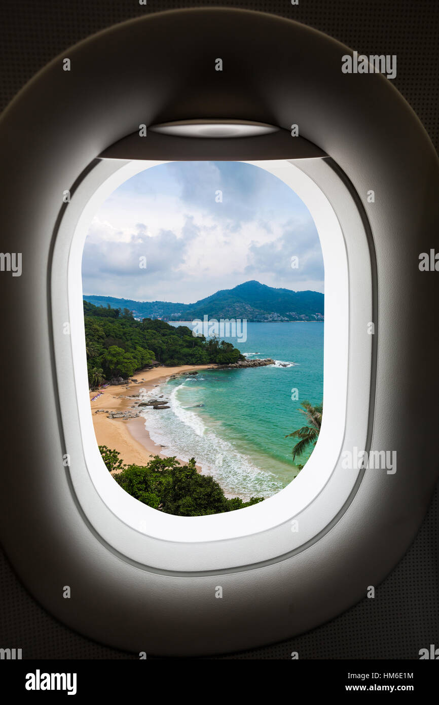 Plane window with island view Stock Photo - Alamy
