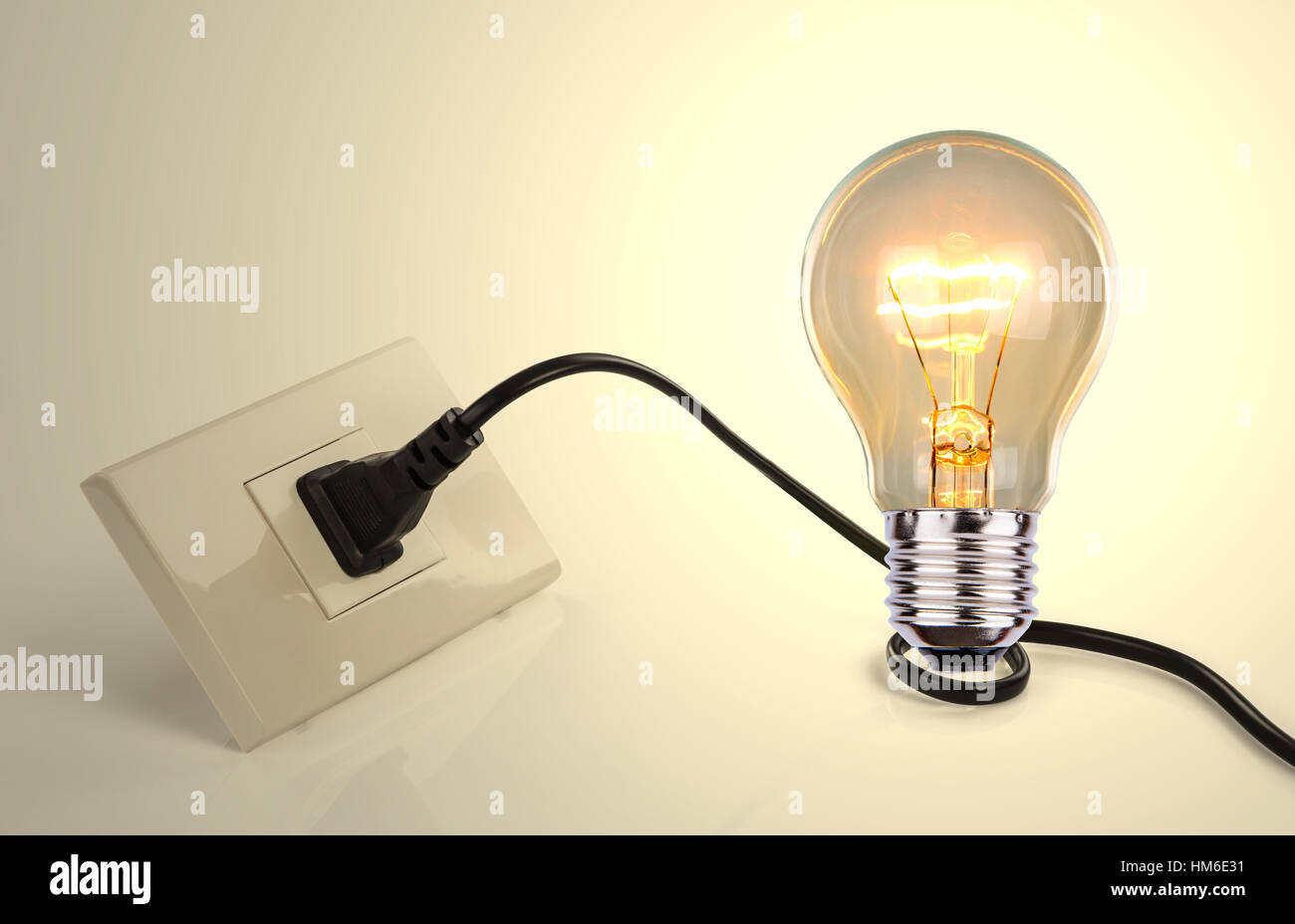 Light bulb and a plug with a cord Stock Photo - Alamy
