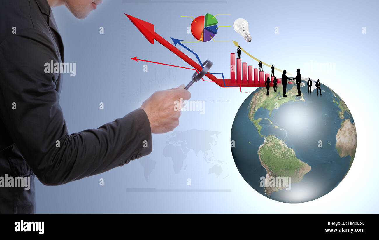 Business man look earth and business graph under a magnifying glass ...