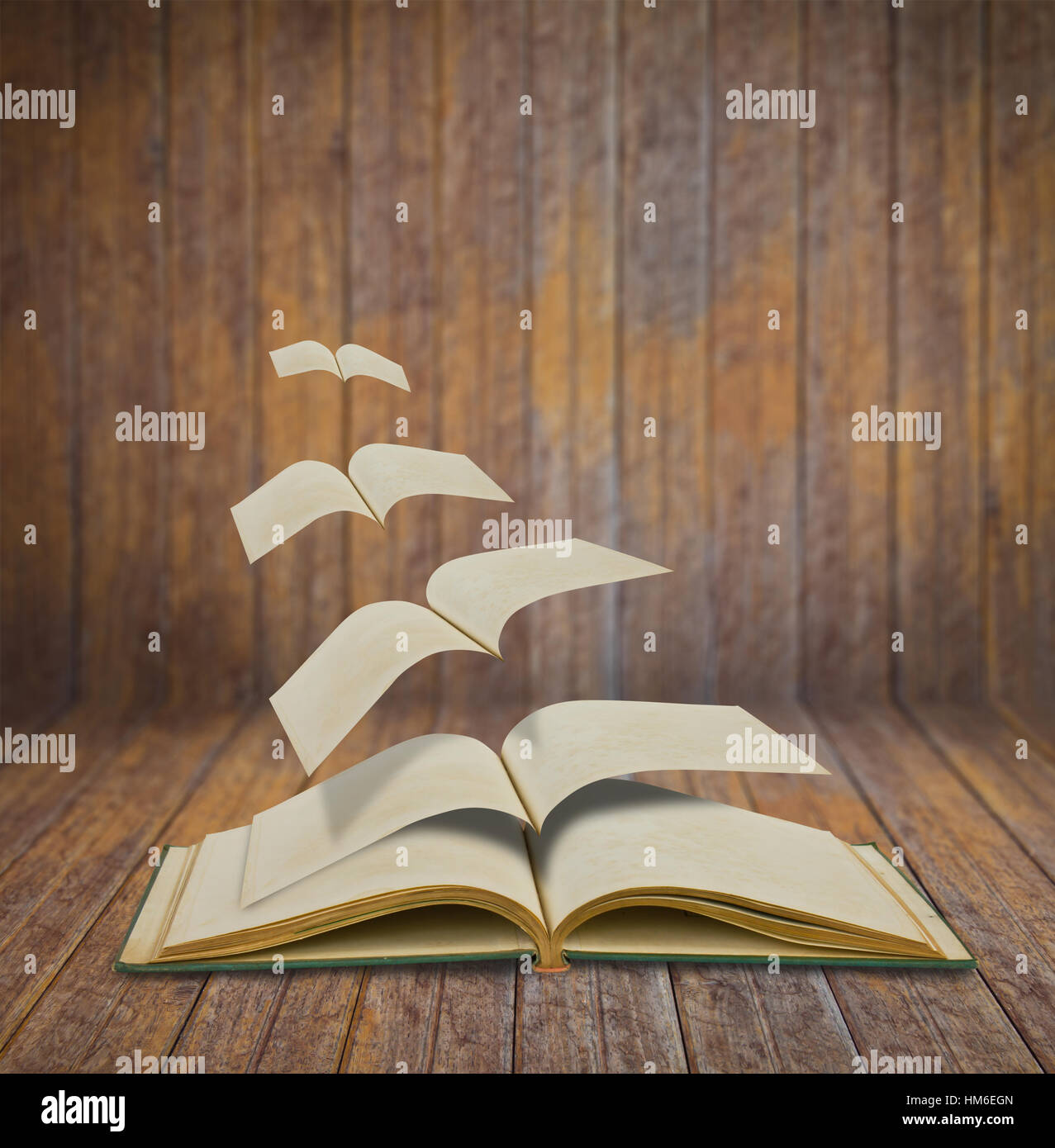 Open flying old books in wood room Stock Photo - Alamy