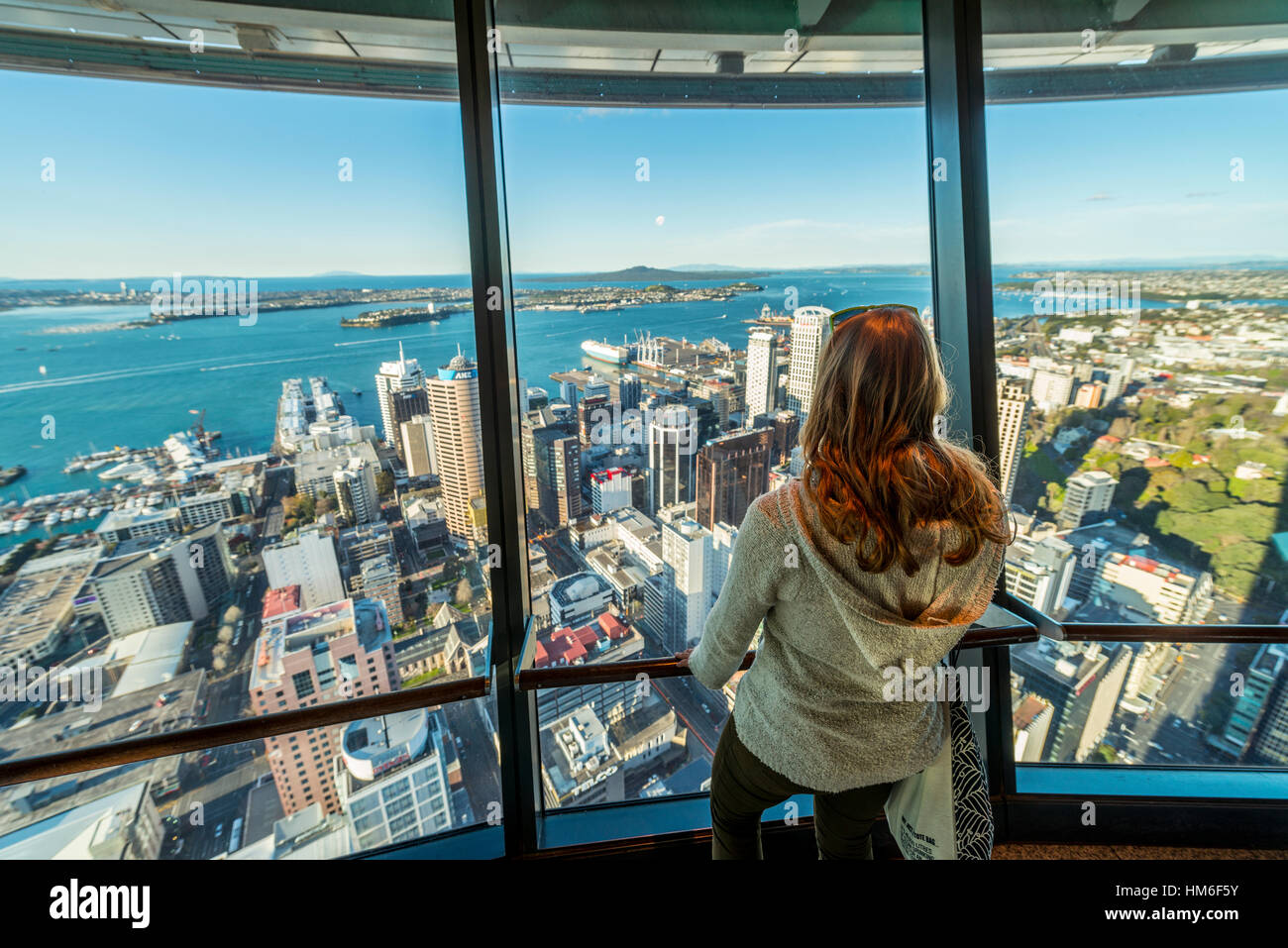 Tourist enjoying the view from the observation deck of the Sky Tower ...