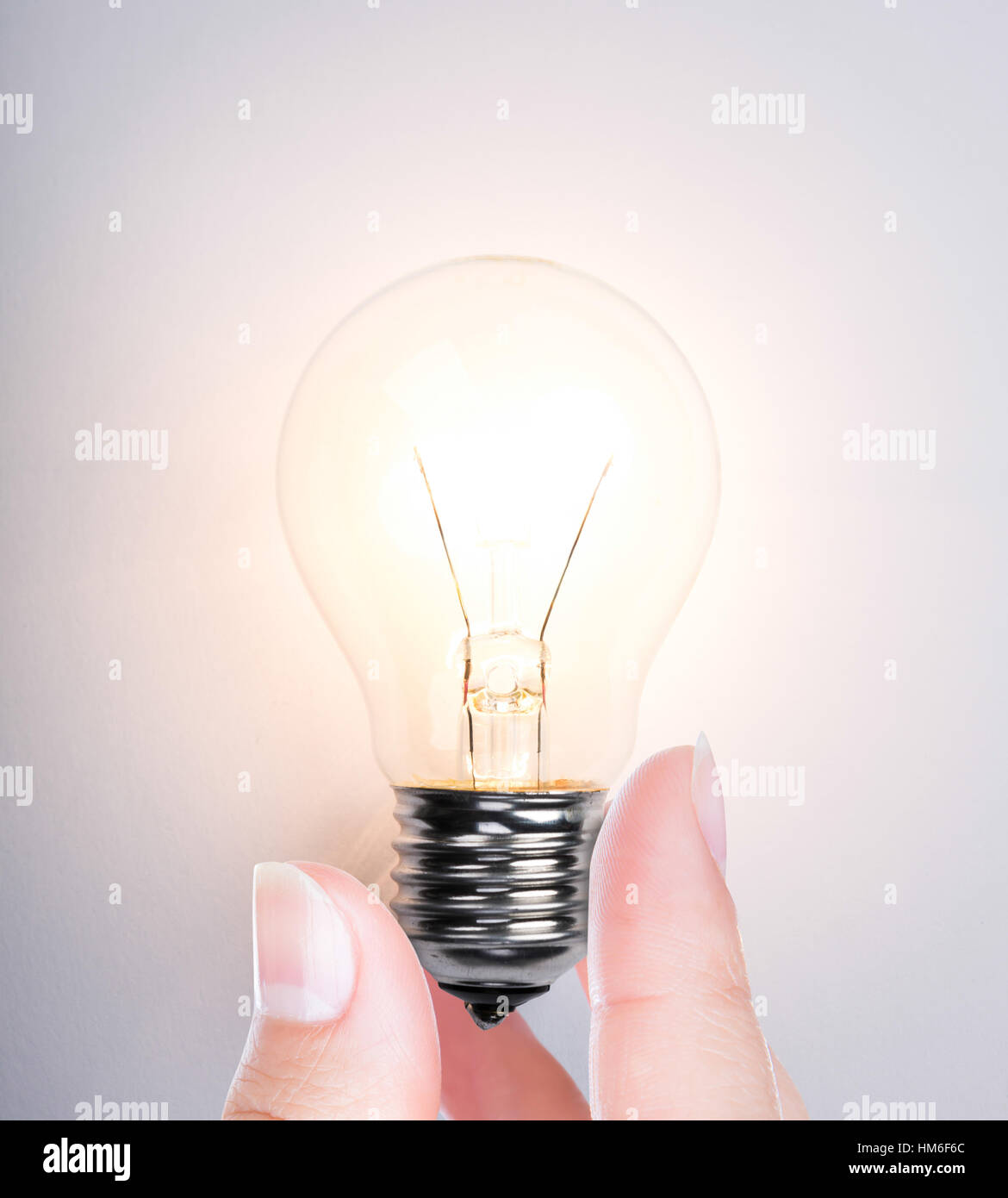 Hand with light bulb Stock Photo - Alamy