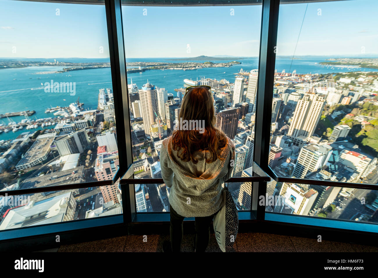 Tourist enjoying the view from the observation deck of the Sky Tower ...