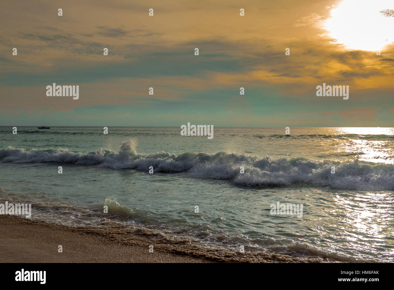 Evening on the sea and the sun gradually disappearing behind the ...