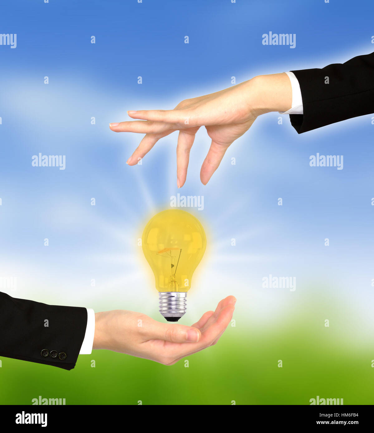 light bulb between two hands Stock Photo - Alamy