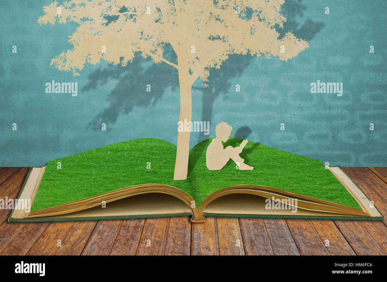 Children reading books under tree hi-res stock photography and images ...