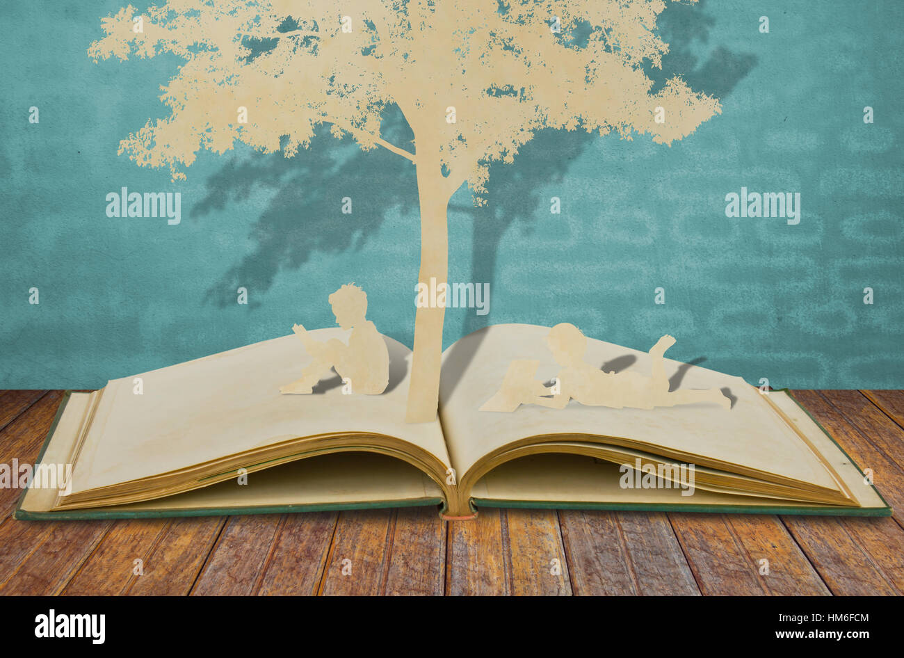 Paper cut of children read a book on old book Stock Photo - Alamy