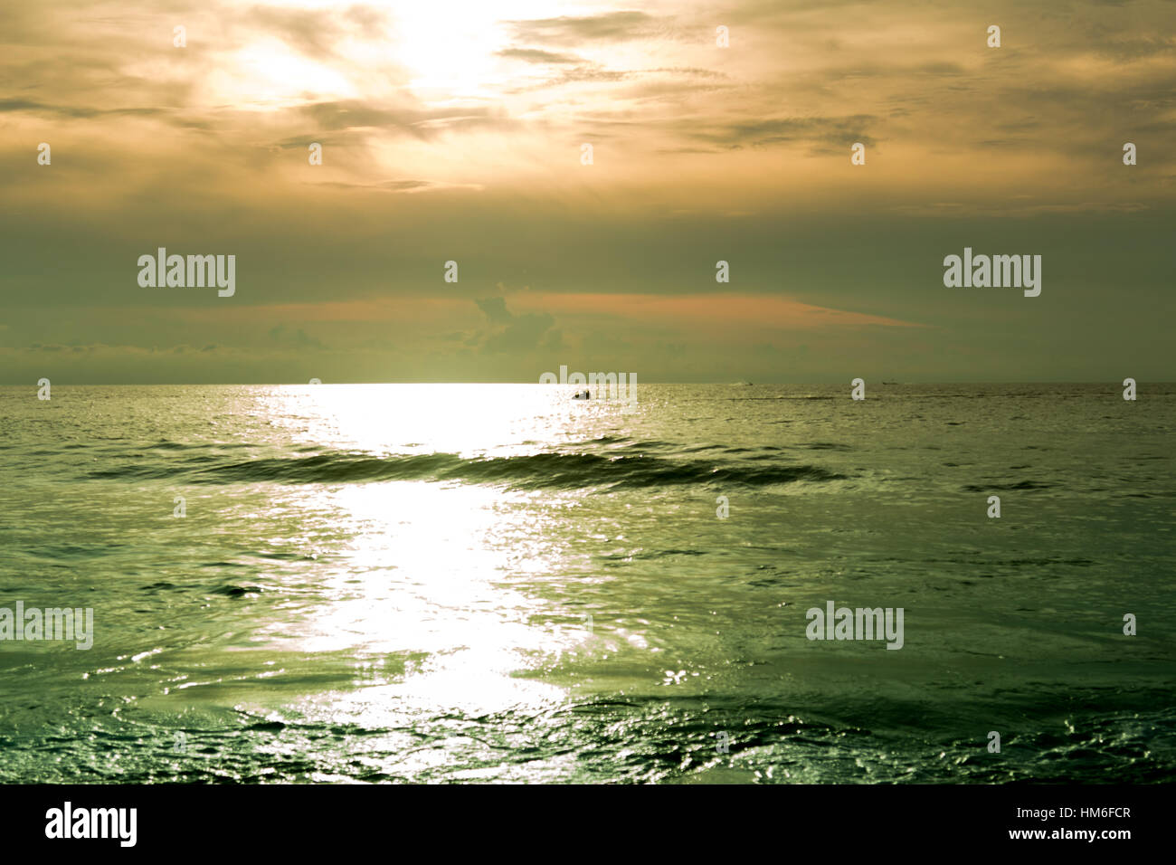 Evening on the sea and the sun gradually disappearing behind the ...