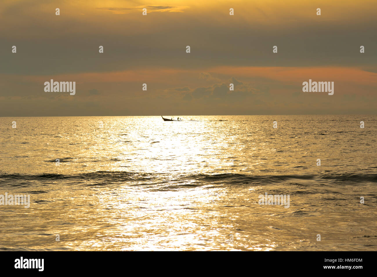 Evening on the sea and the sun gradually disappearing behind the ...