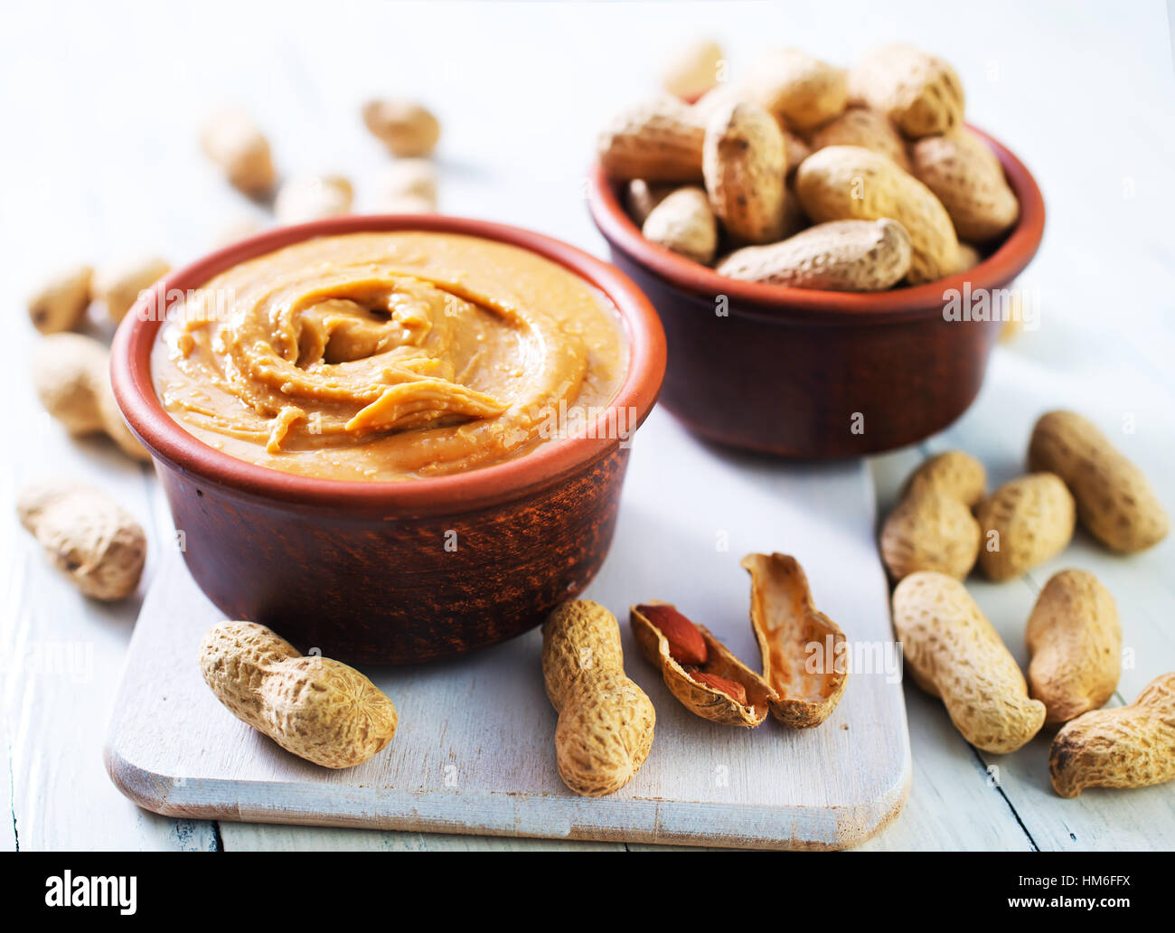 peanuts butter in bowl and on a table Stock Photo - Alamy