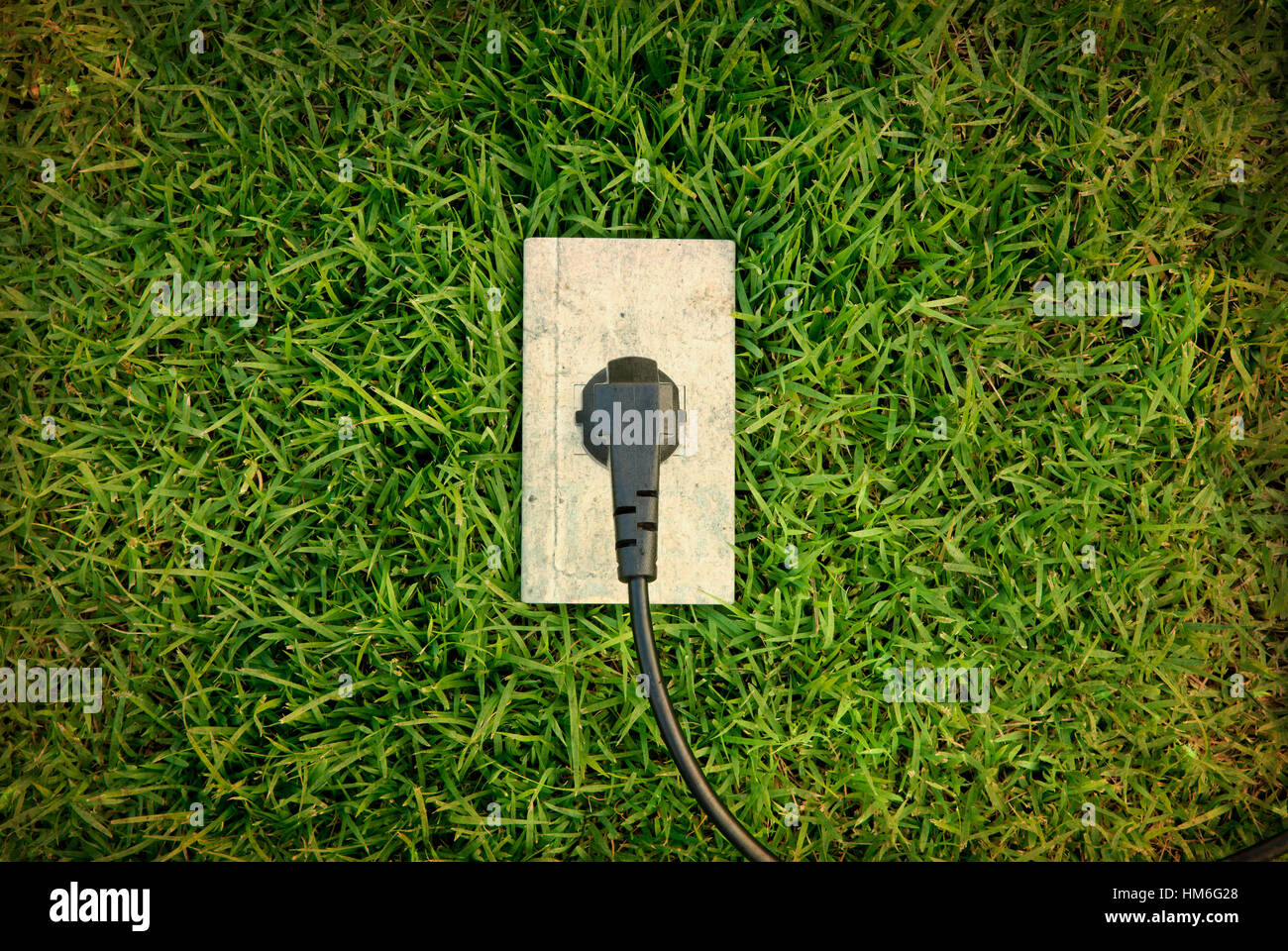 Green energy concept : outlet in grass Stock Photo - Alamy