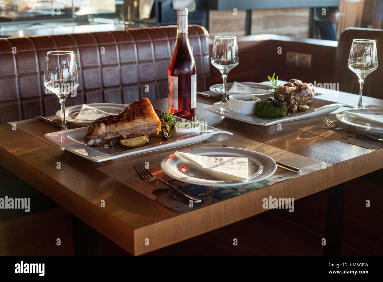 Restaurant table with food and red wine Stock Photo - Alamy