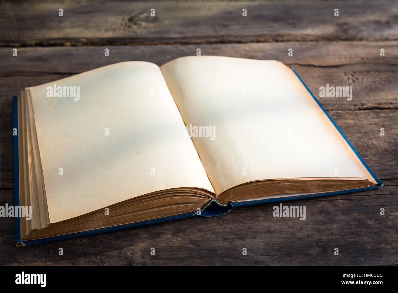 Open blank pages of old book on wood background Stock Photo - Alamy