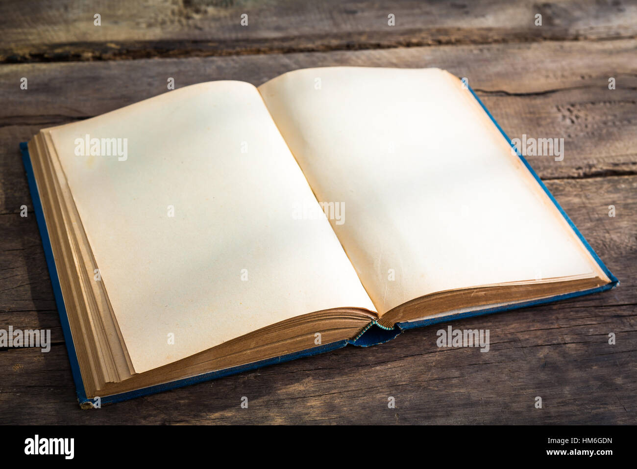 Open blank pages of old book on wood background Stock Photo - Alamy