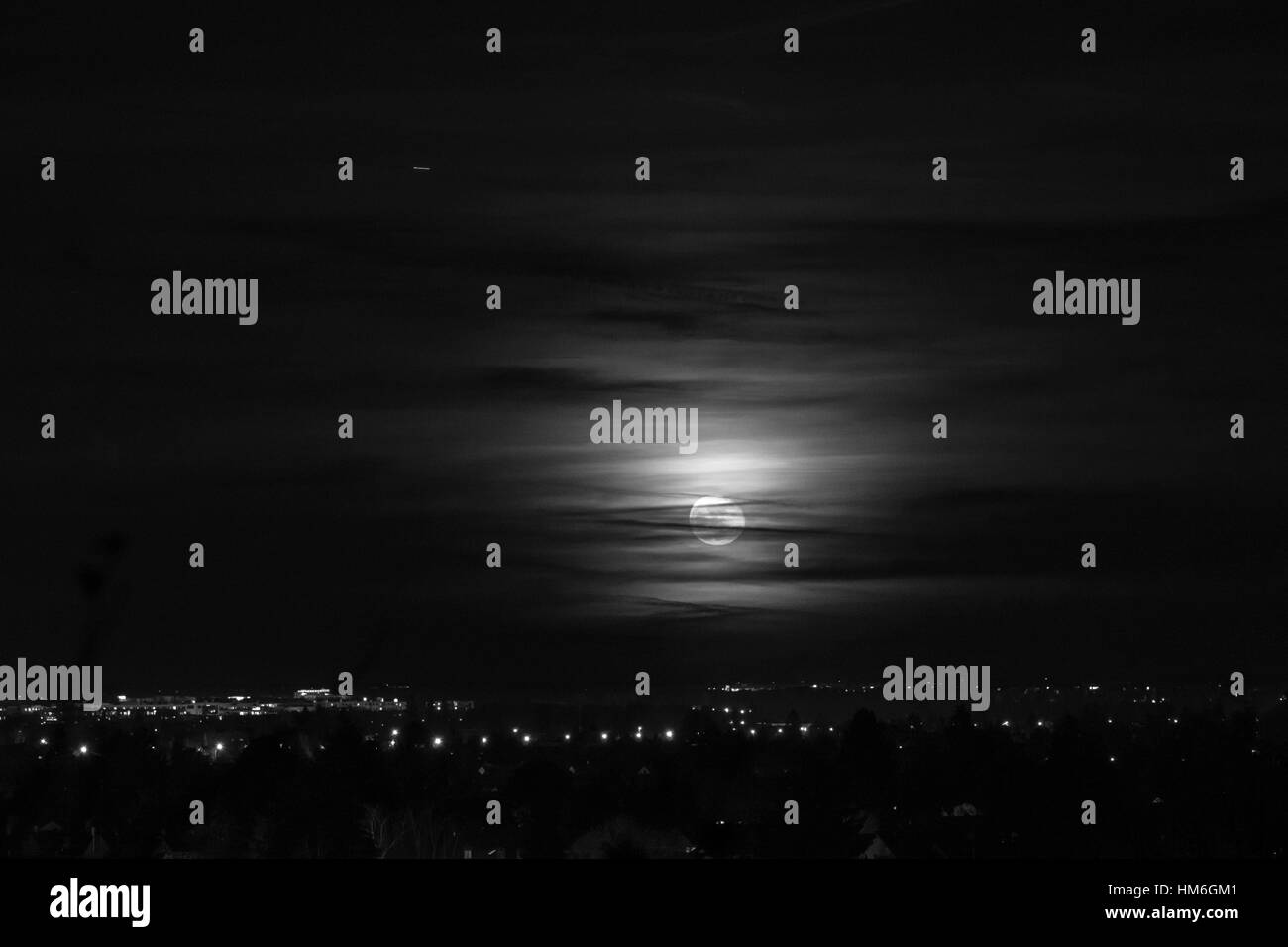 Moon rising behind clouds hi-res stock photography and images - Alamy