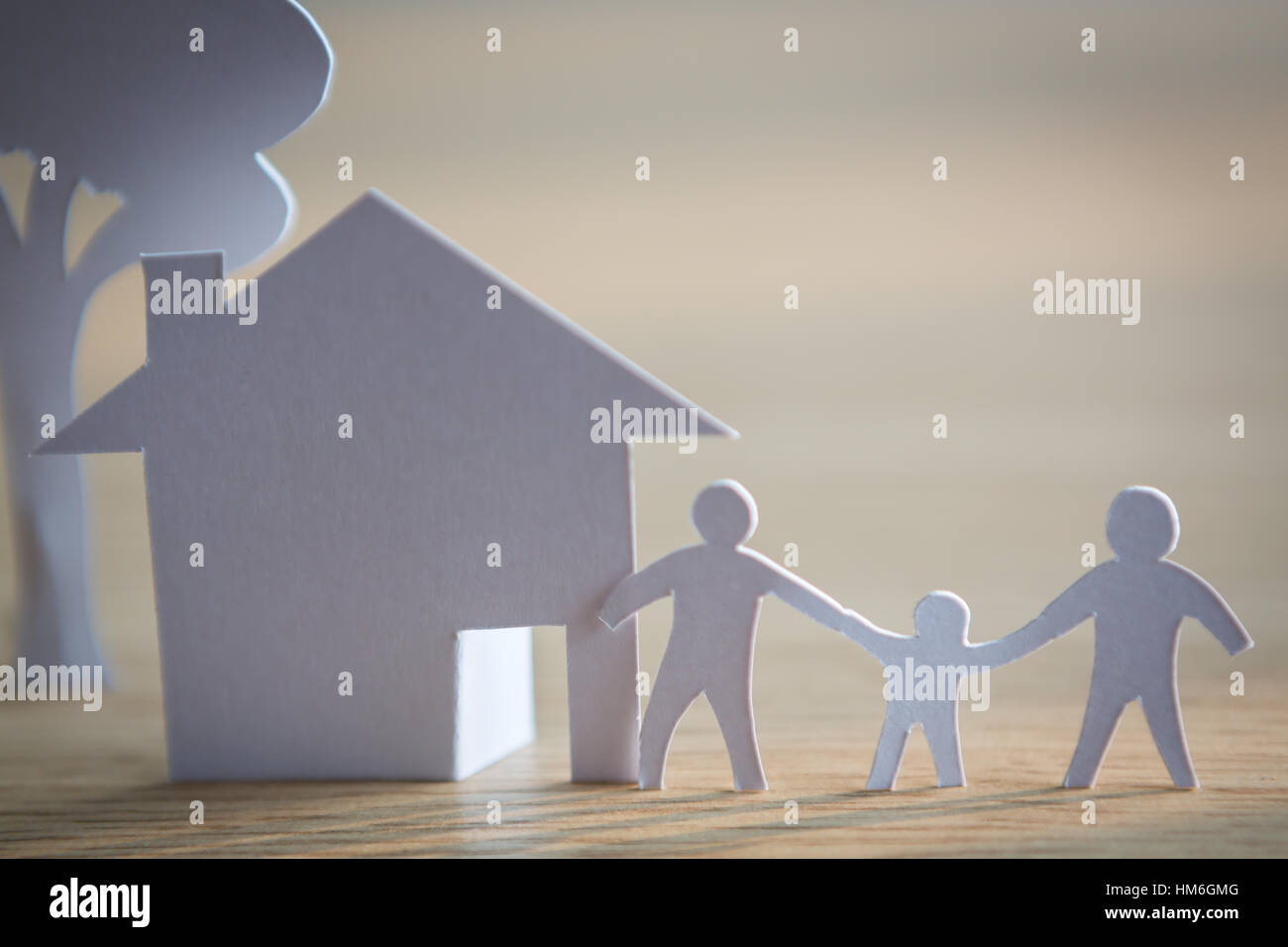 Paper cut of family with house and tree Stock Photo - Alamy