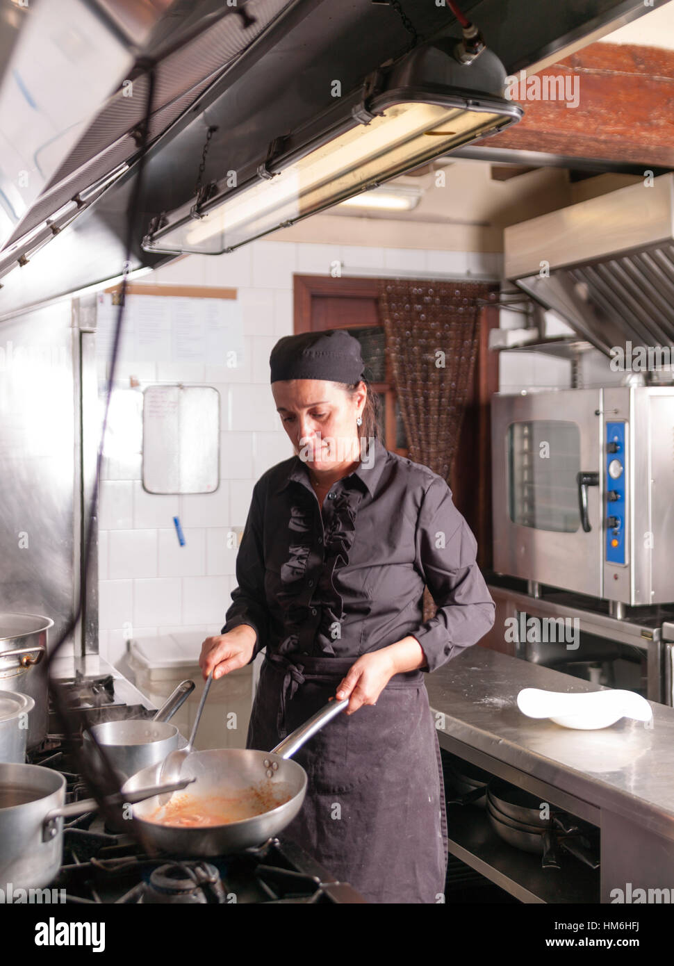 Chef Marina Morelli cooking in her restaurant Hosteria 700, Cremona ...