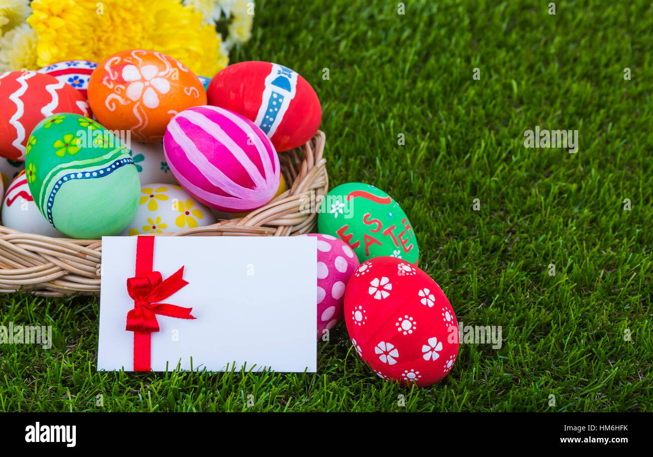 Basket of easter eggs with card on Fresh Green Grass Stock Photo - Alamy