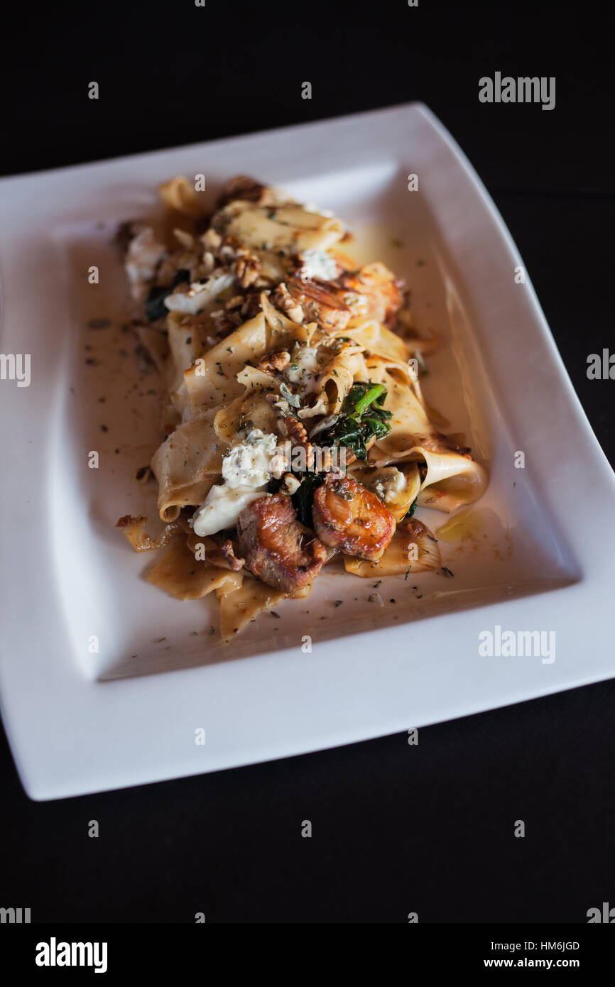 Pasta with chicken in horizontal dish with black background Stock Photo ...