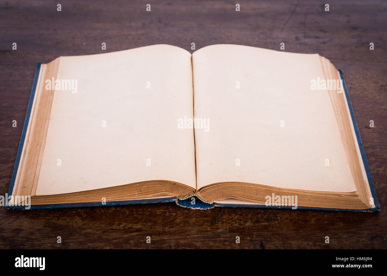 Open old vintage book on wooden background Stock Photo - Alamy
