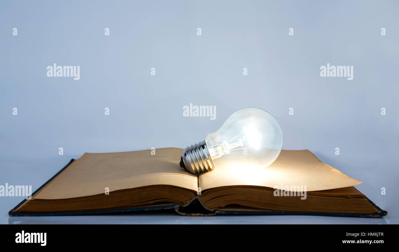 Book and light bulb Stock Photo - Alamy