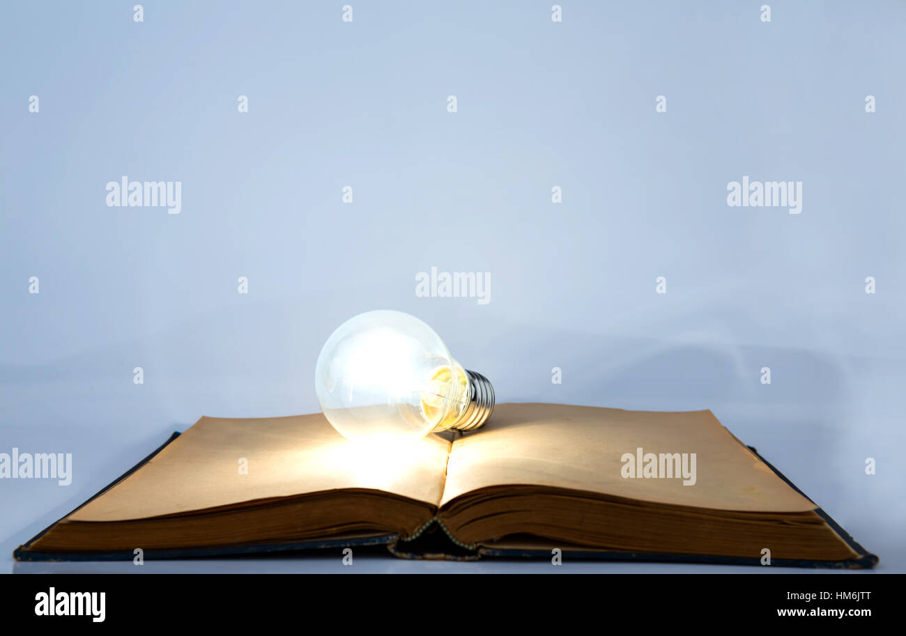 Book and light bulb Stock Photo - Alamy