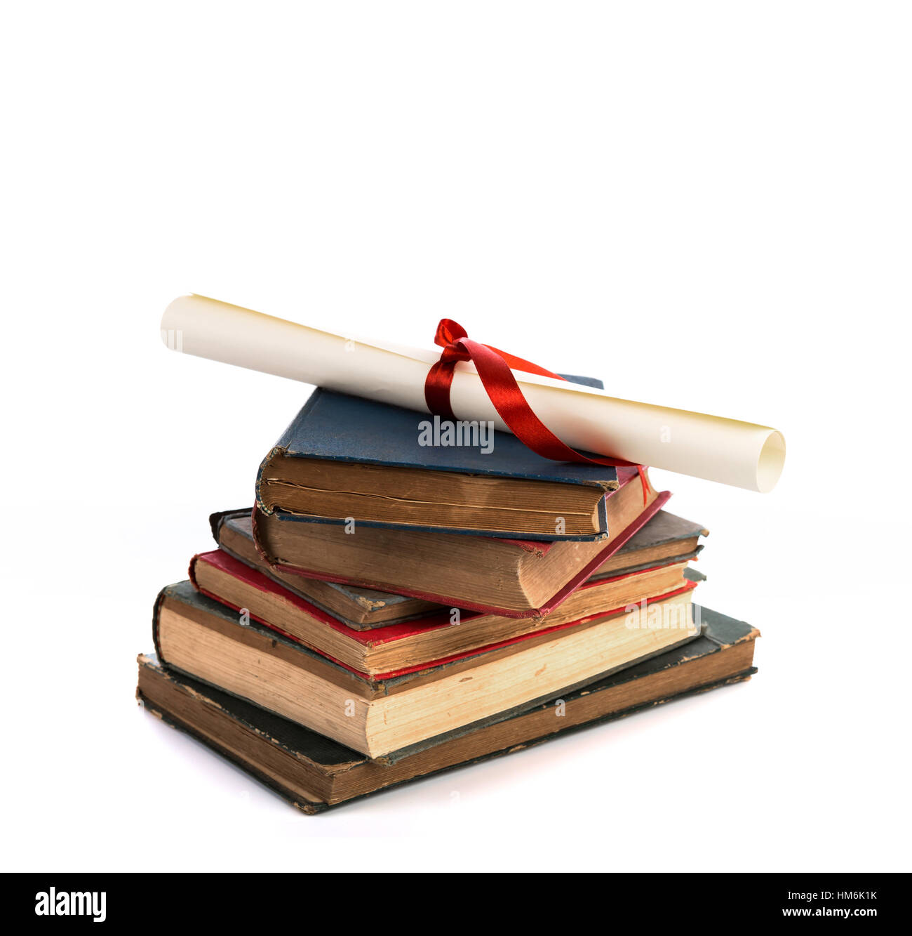 Diploma with old book isolated on a white background Stock Photo - Alamy